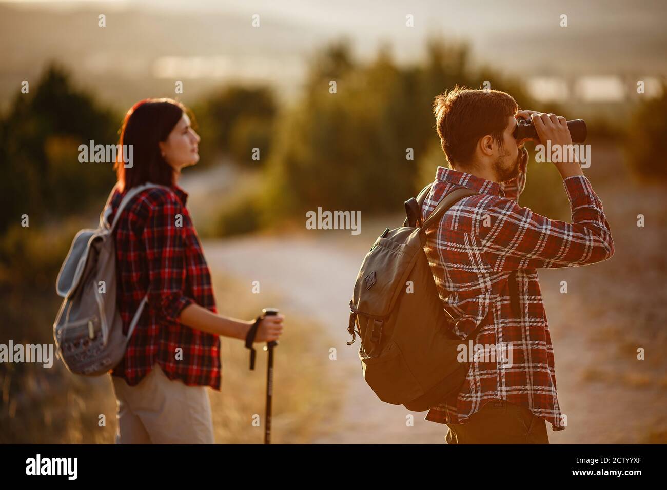 Portrait of happy young couple having fun on their hiking trip ...