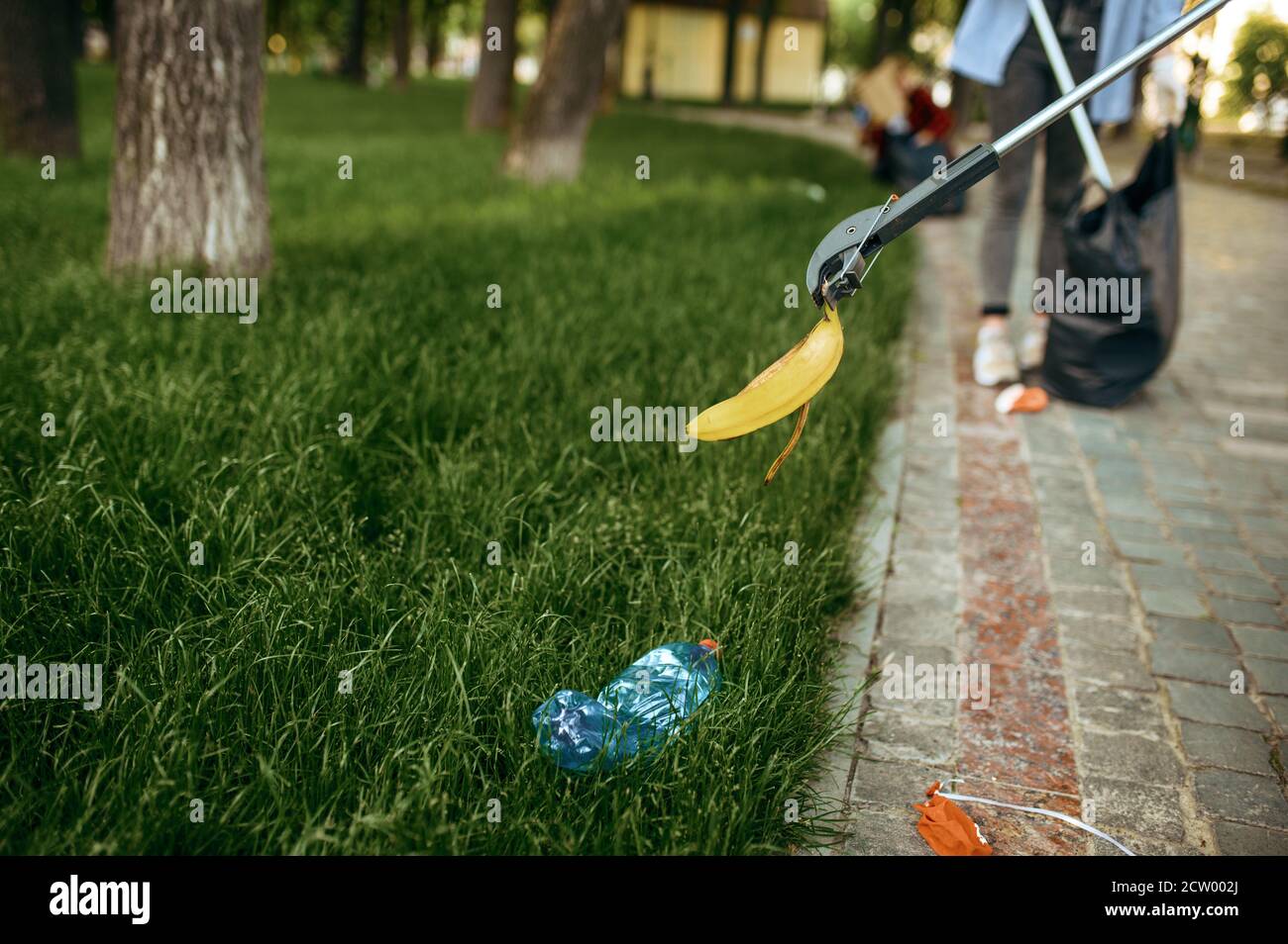 Cleaning garbage from grass in hi-res stock photography and images - Alamy