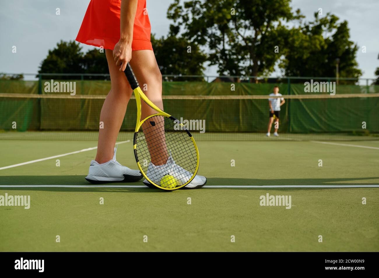 Tennis players with rackets on outdoor court Stock Photo - Alamy