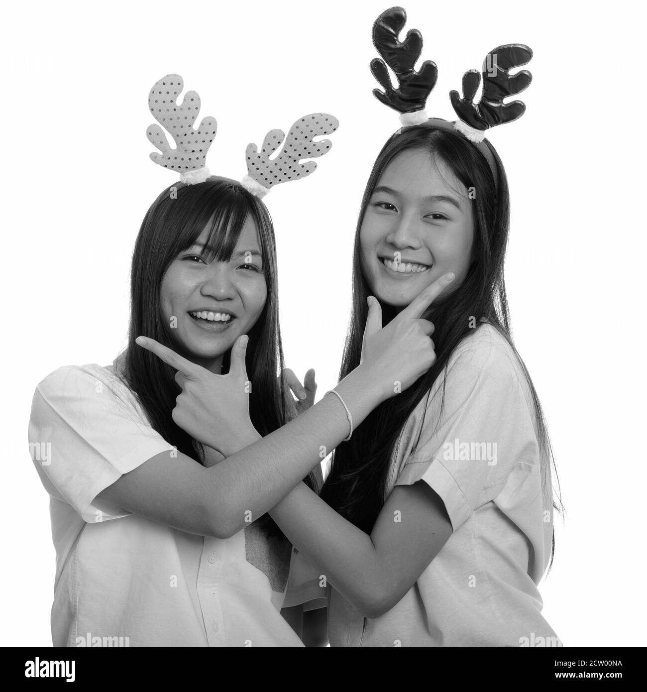 Two Young Happy Asian Teenage Girls Smiling And Posing Together Ready