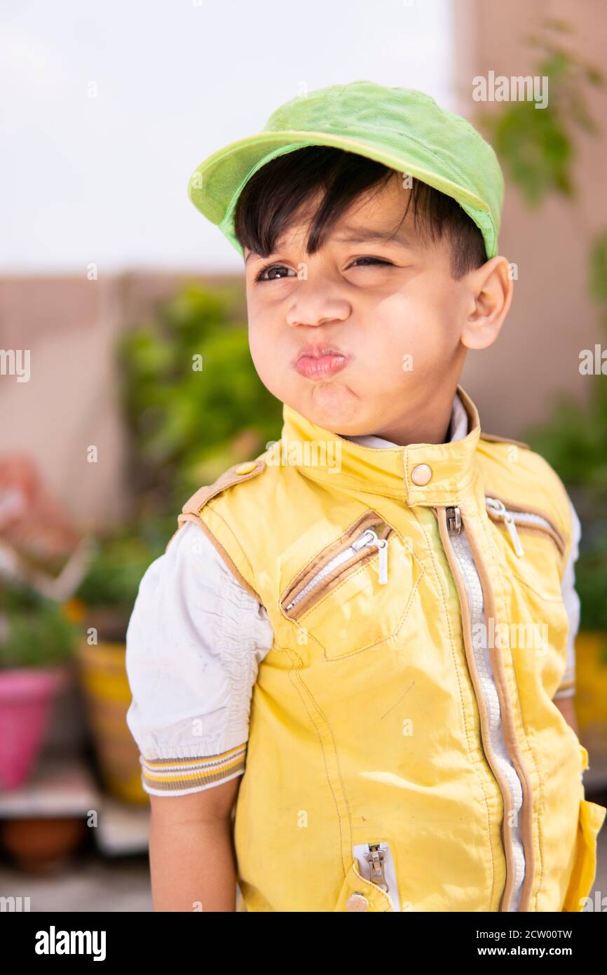 Cut little boy having fun and making funny pout face Stock Photo - Alamy