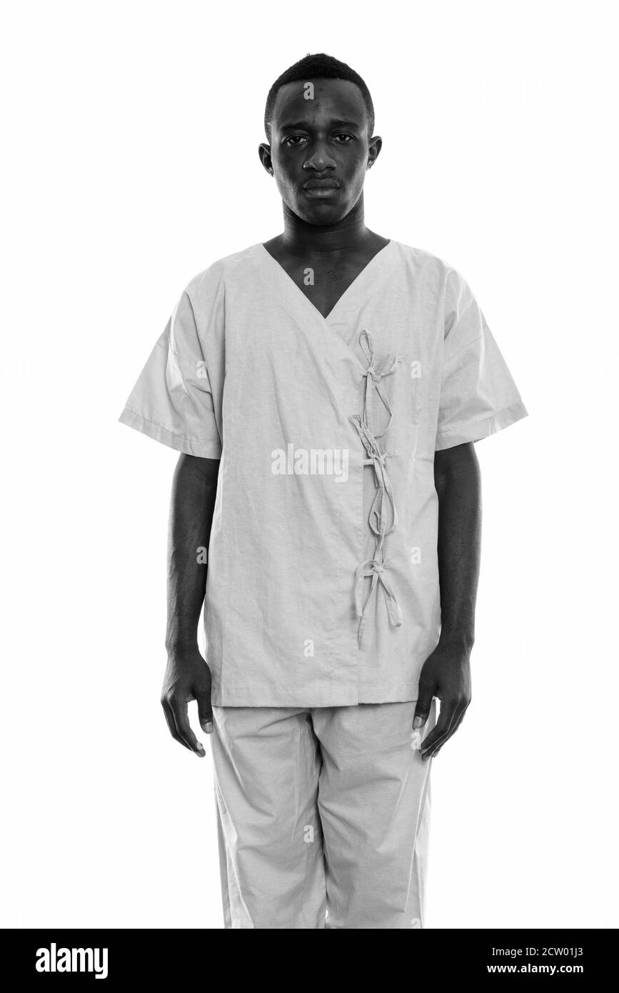 Studio shot of young black African man patient standing Stock Photo - Alamy