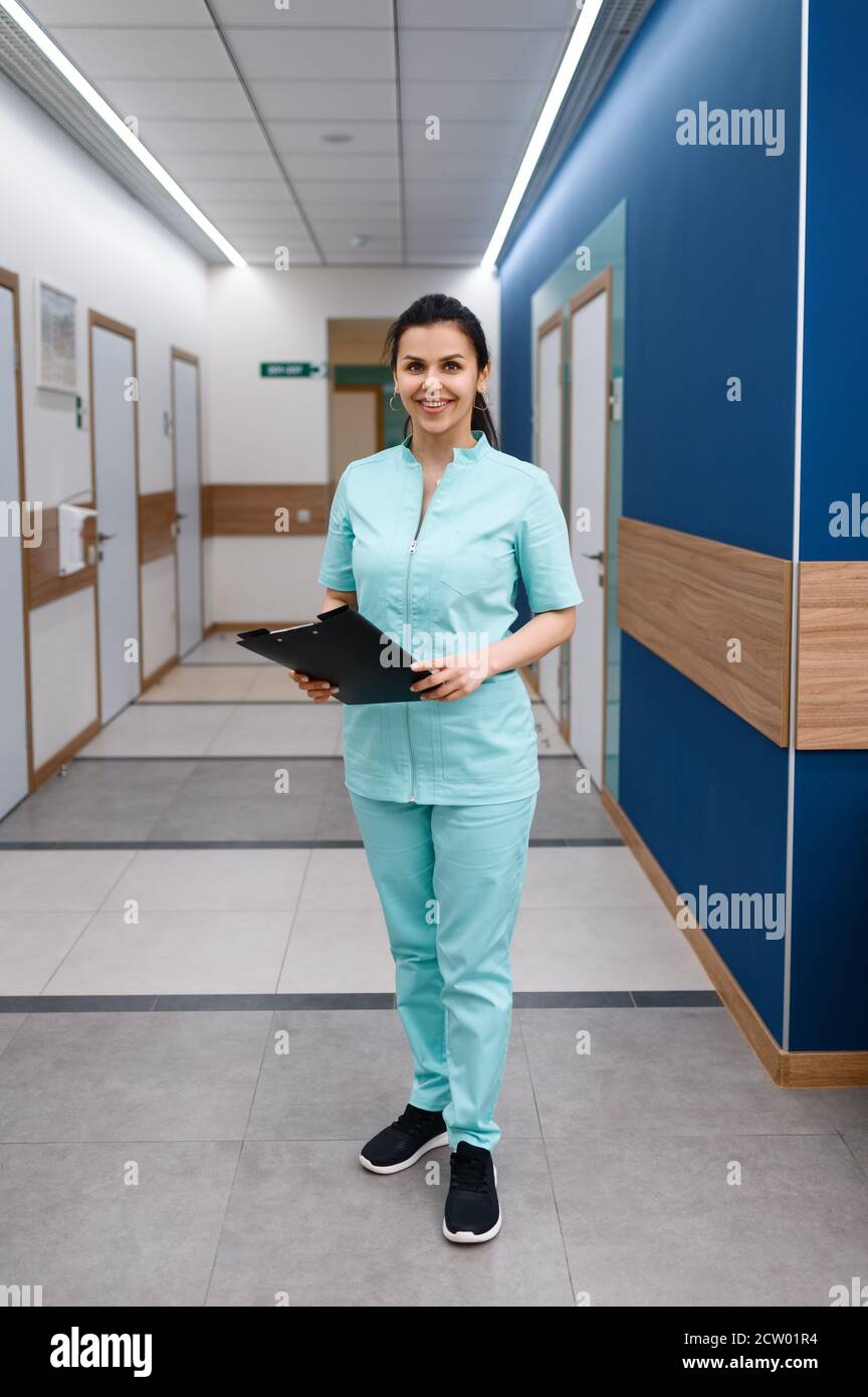 Smiling female doctor poses in clinic Stock Photo - Alamy