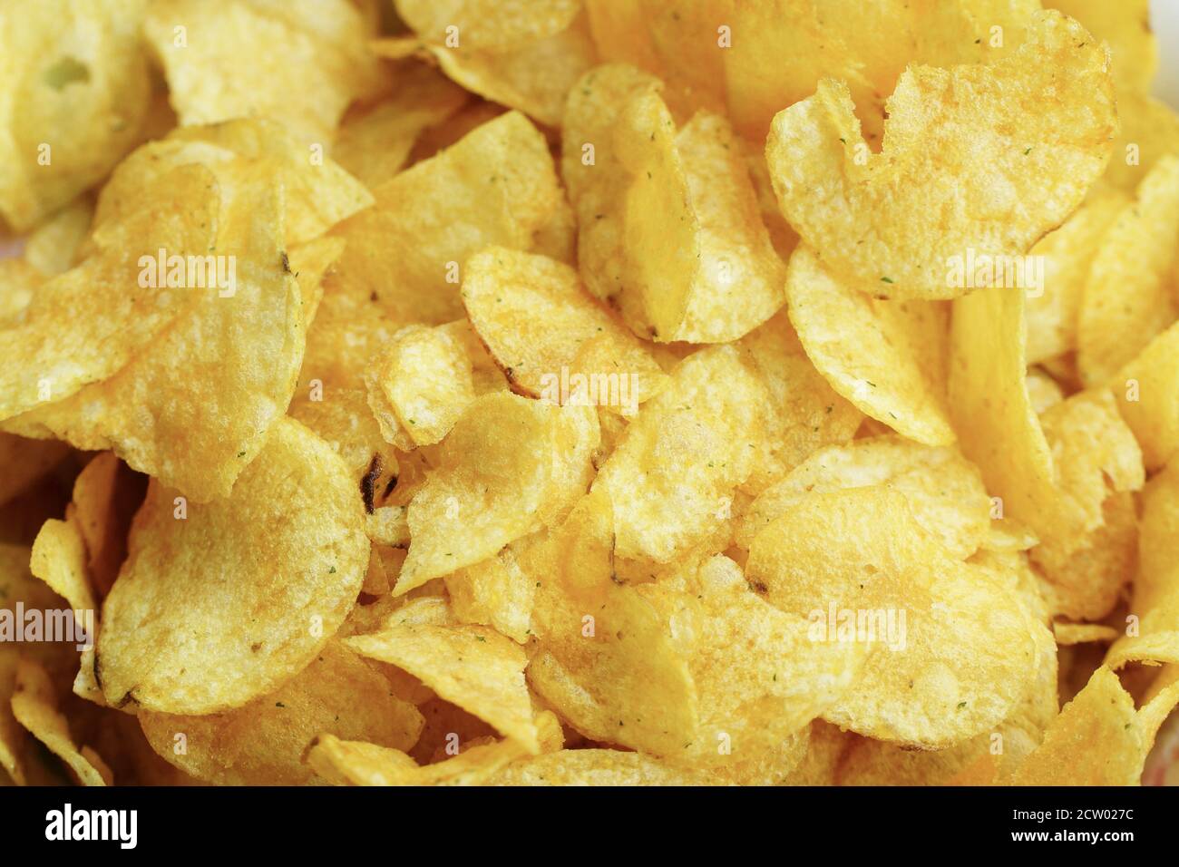 Pile of salty potato chips for background Stock Photo - Alamy