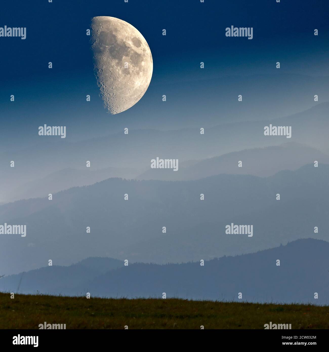 The moon over a evening landscape Stock Photo - Alamy