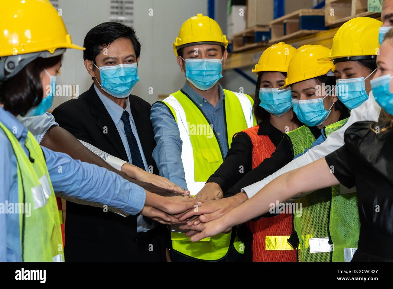 Group of factory industry worker working with face mask to prevent ...
