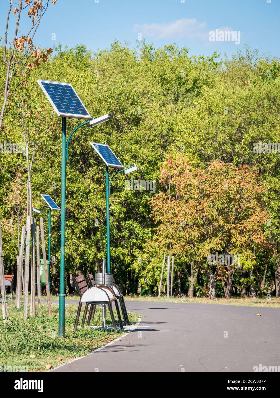 Alley in the park with lighting poles and photovoltaic panel LED lamp ...
