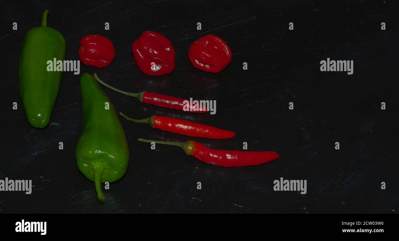 slate plate of different types of red and green hot peppers such as ...