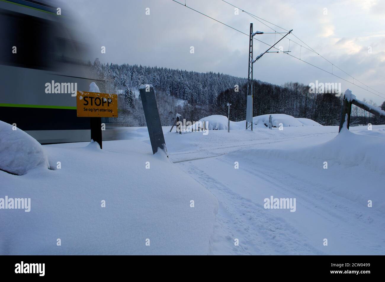 Norwegian train passing rail crossing in high speed in wintertime with ...