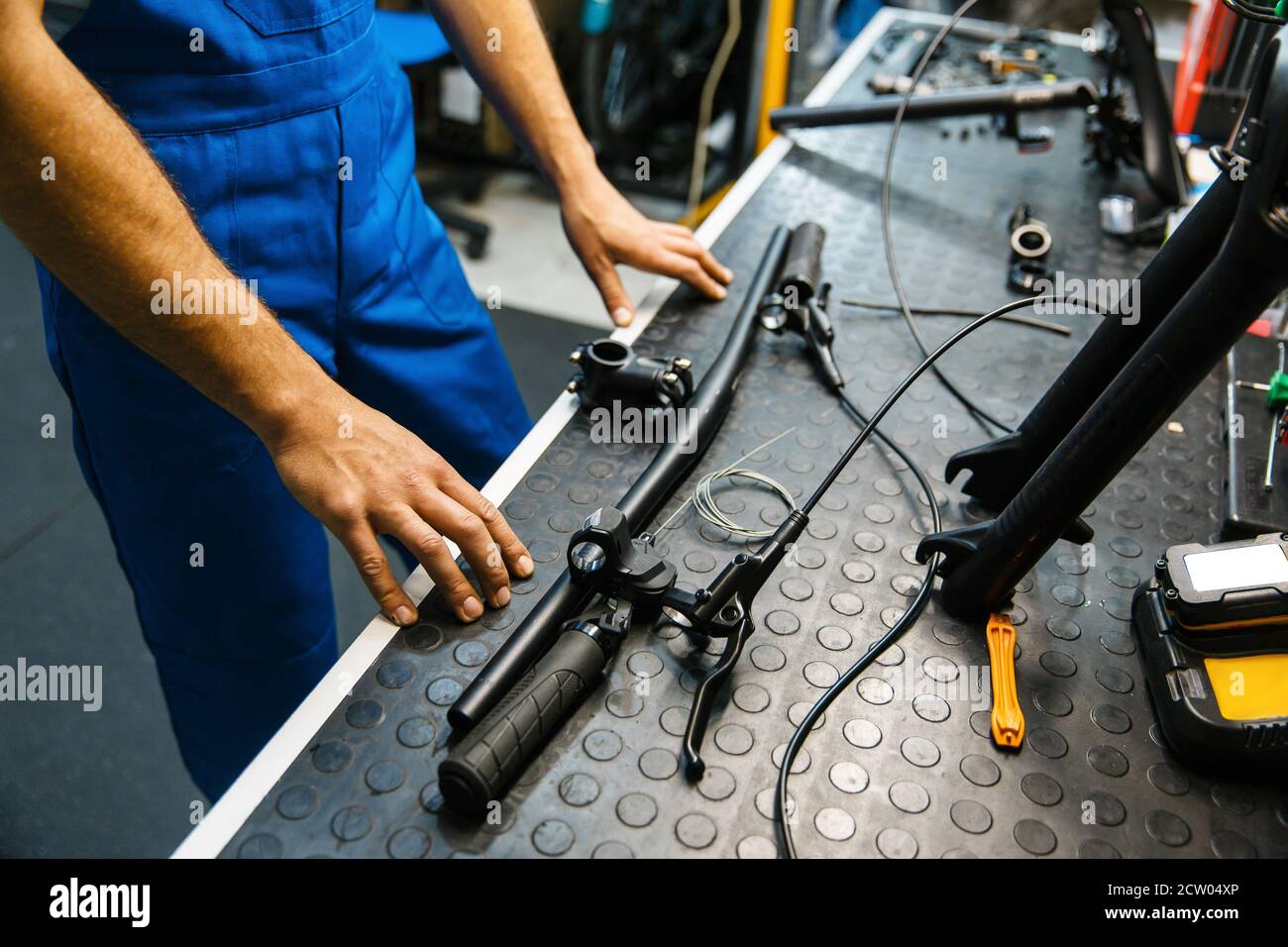 Bicycle assembly, man installs handlebar Stock Photo - Alamy