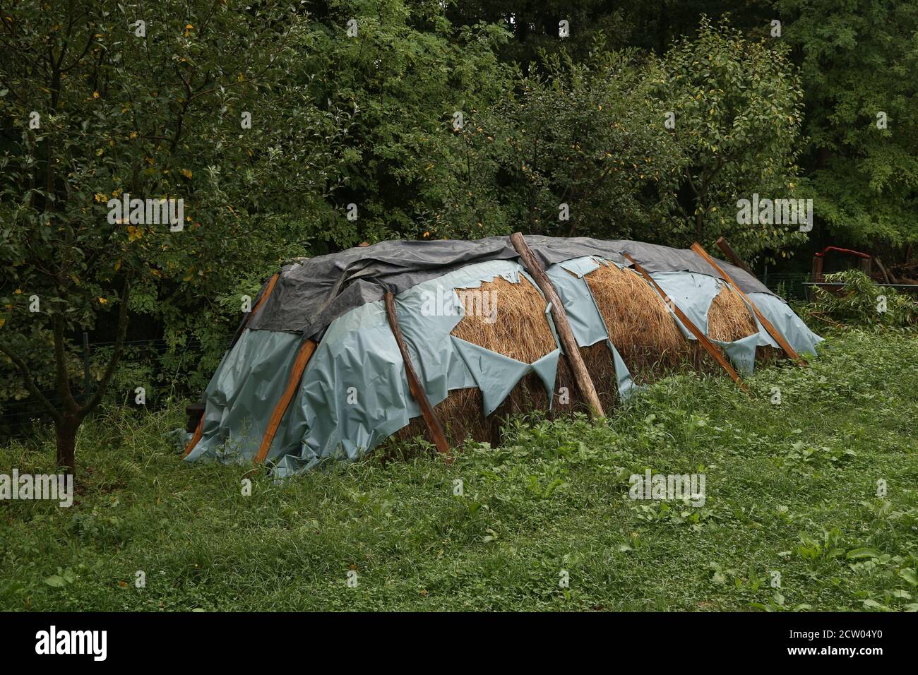 The haystack is covered with plastic from the rain Stock Photo - Alamy