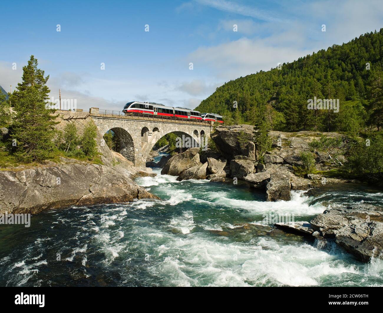 Train crossing old stone bridge on the Rauma Line, Romsdalen, Norway ...