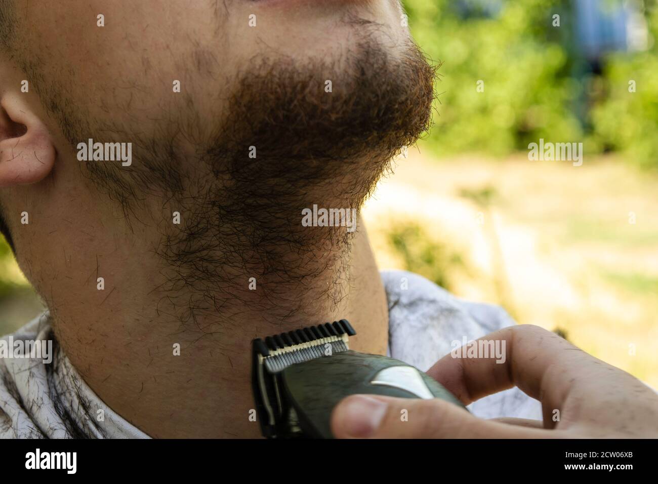 the barber cuts his beard to the guy with a shearing machine Stock ...