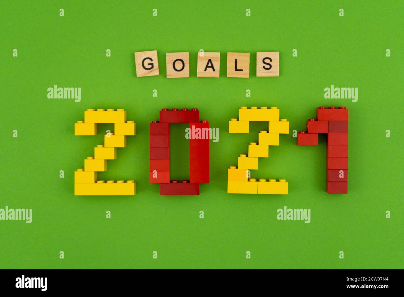 The word goals 2021 is lined with wooden letters on a green background ...