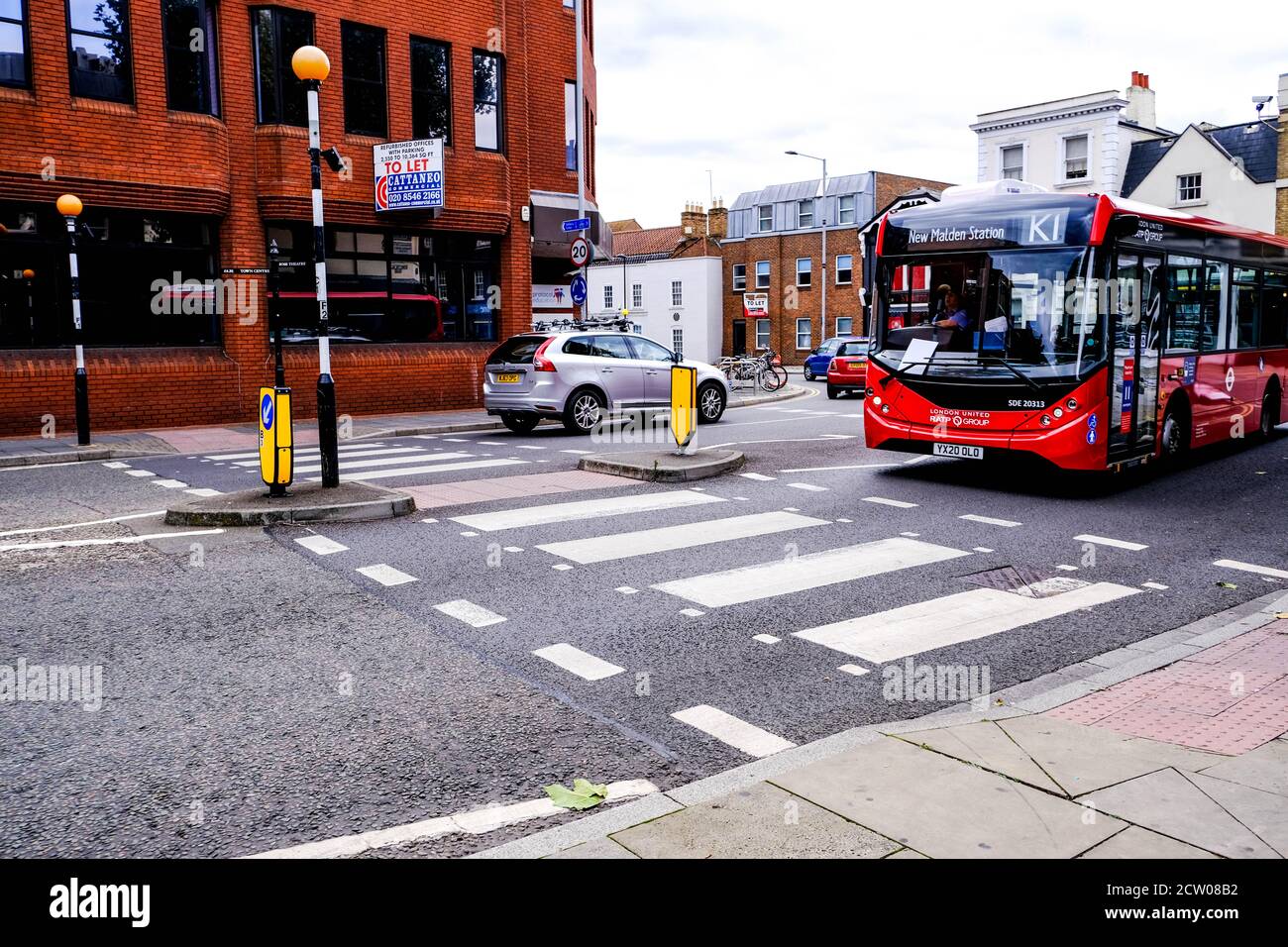 Single Decker Red Transport Fot London Bus Approching A Zebra Or ...