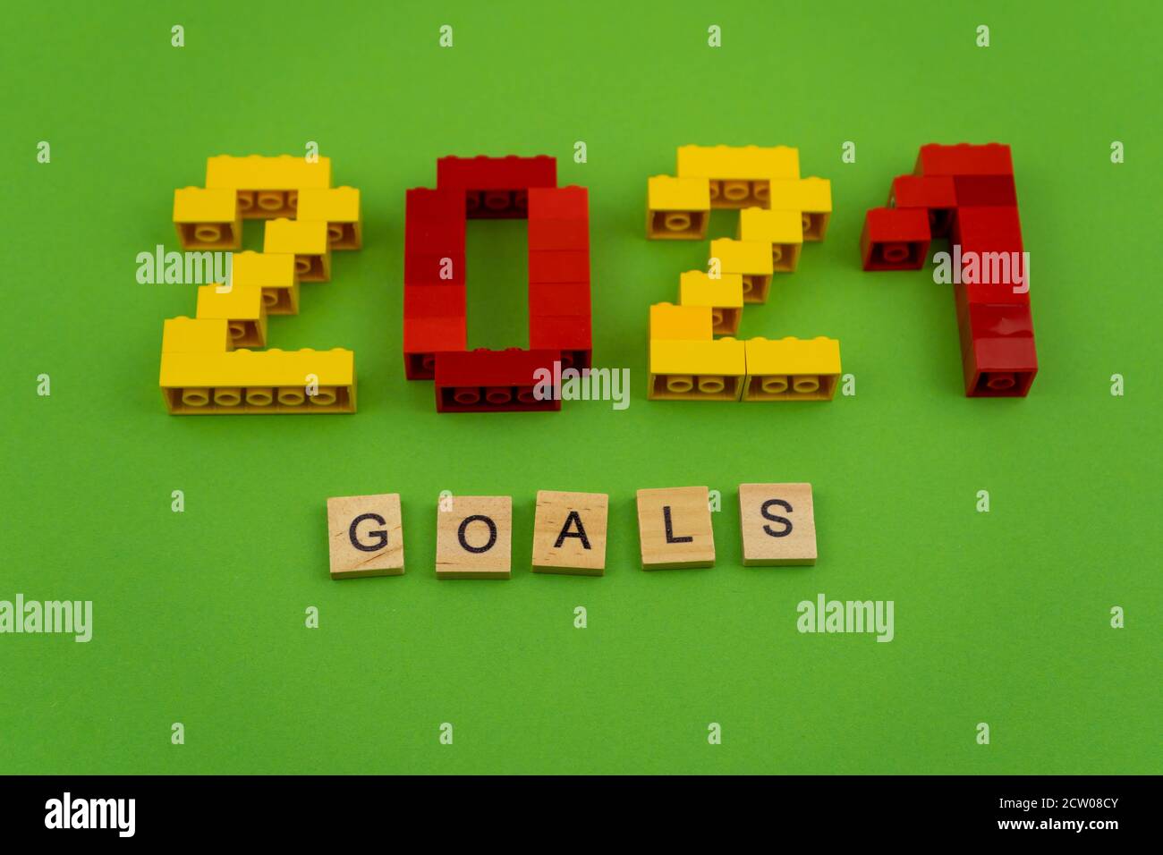 The word goals 2021 is lined with wooden letters on a green background ...