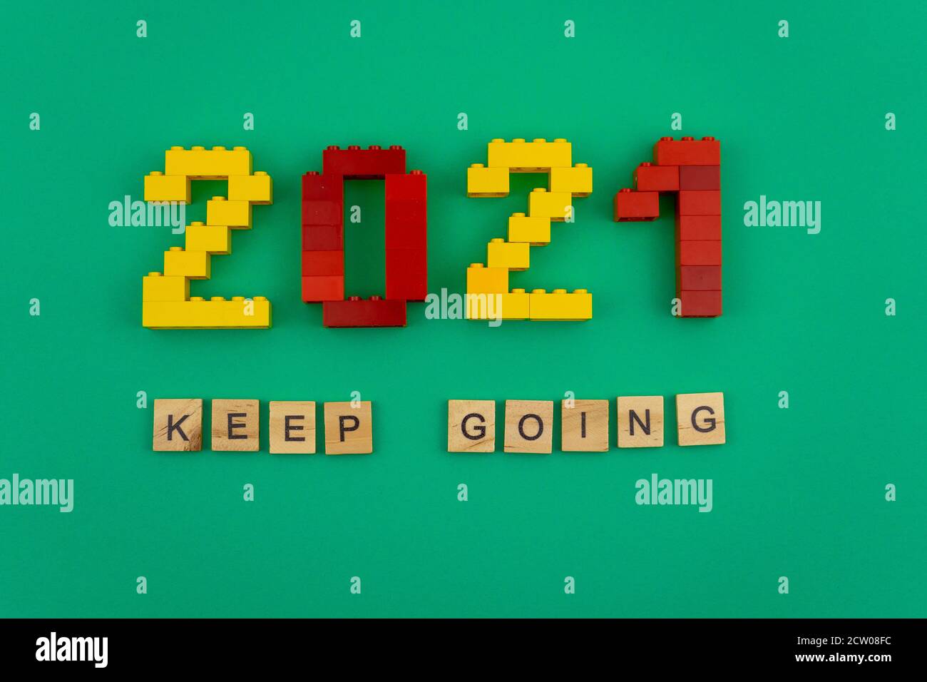 The words keep going 2021 is lined with wooden letters on a green ...