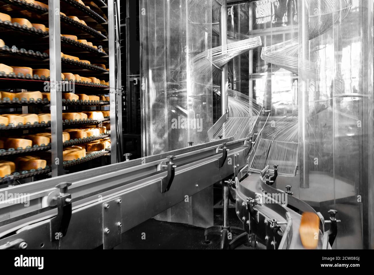 Automatic production line Baked breads from hot oven Stock Photo - Alamy