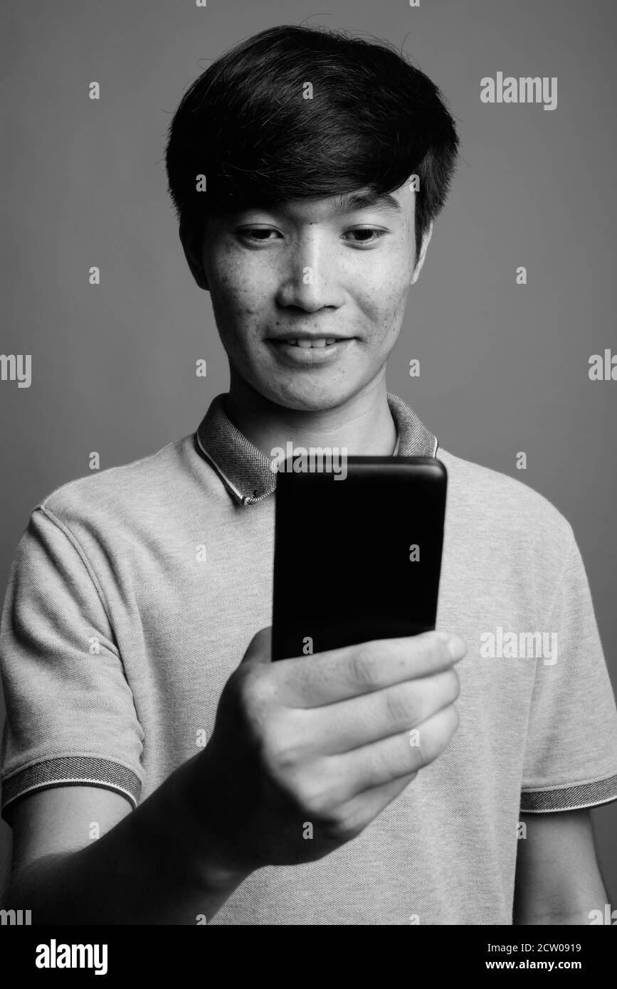 Asian male teen phone hi-res stock photography and images - Alamy