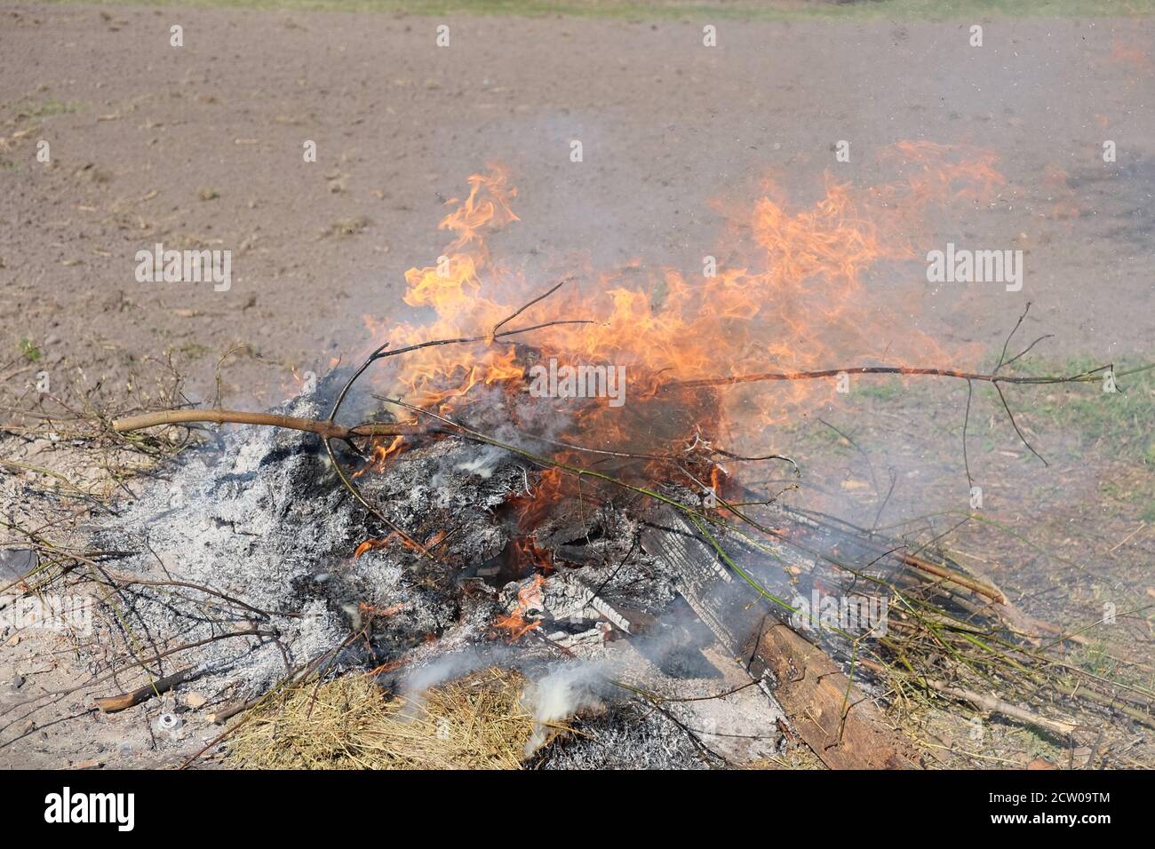 Big bonfire in the open air. A pile of ash from burnt boards and ...
