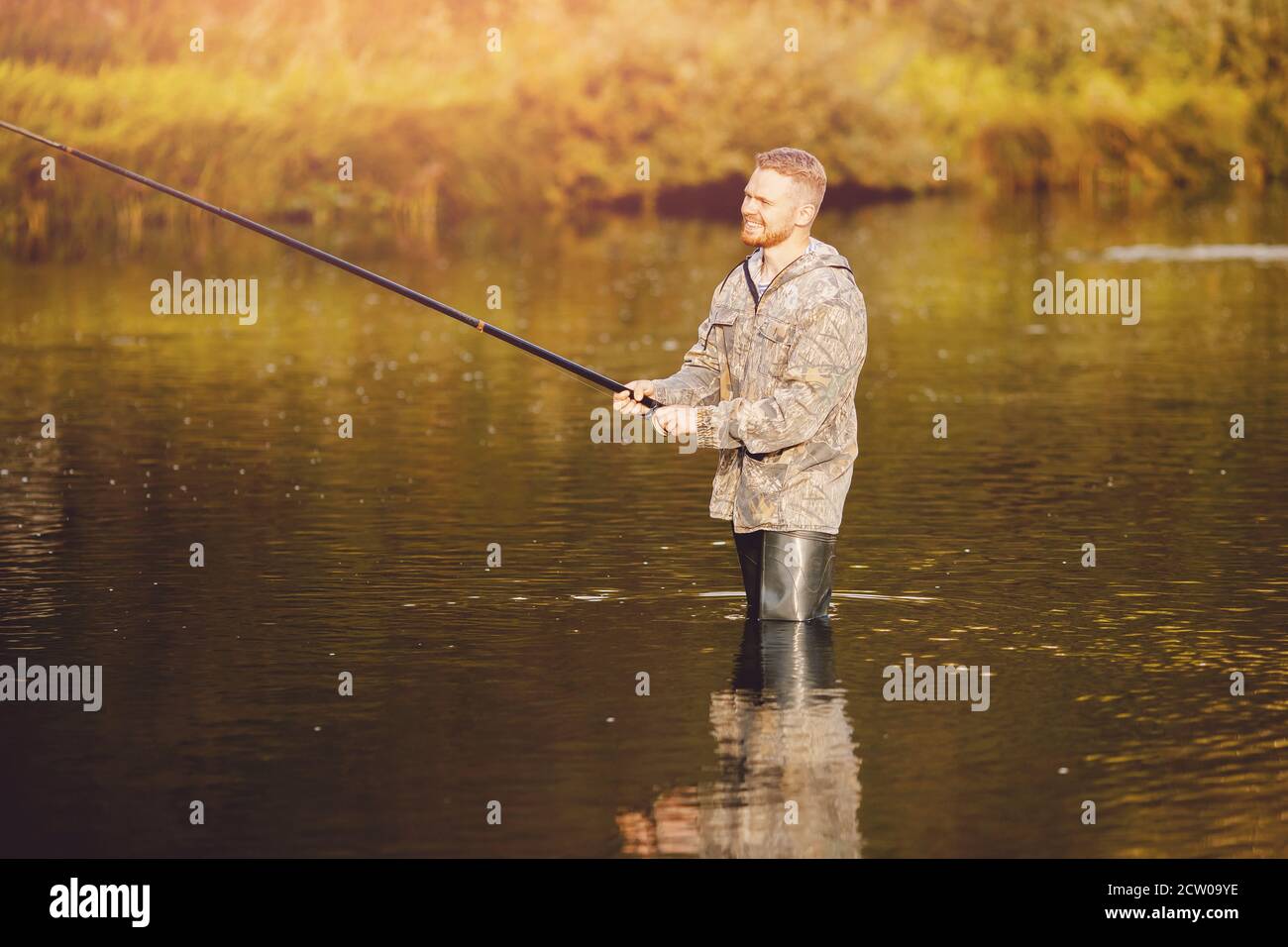 Fisherman using rod fly fishing in mountain river autumn splashing ...