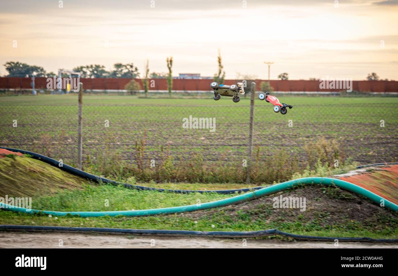Two buggies in air after launching from a big jump on an outdoor track ...