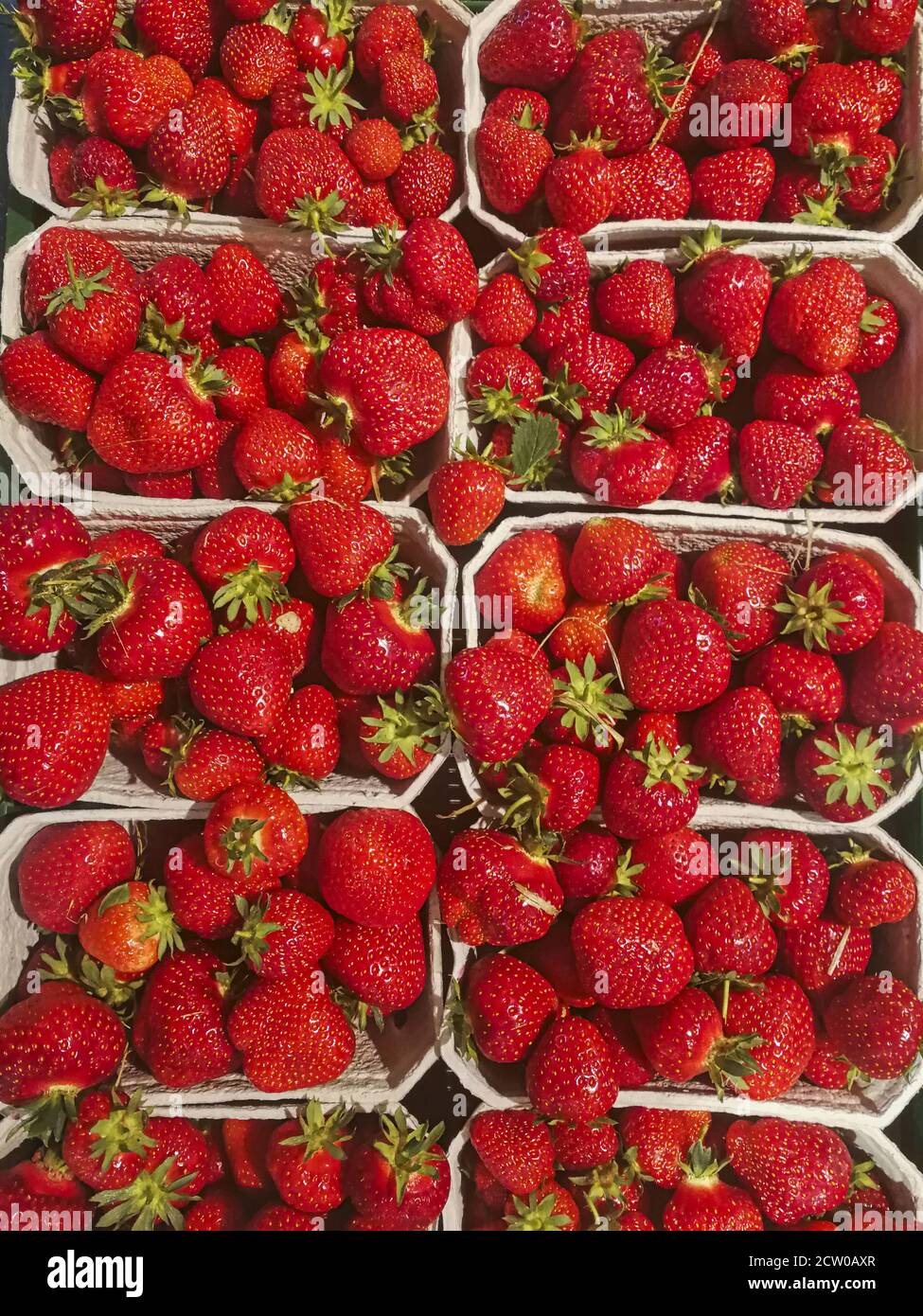 Strawberries in cardboard bowls for sale Stock Photo - Alamy