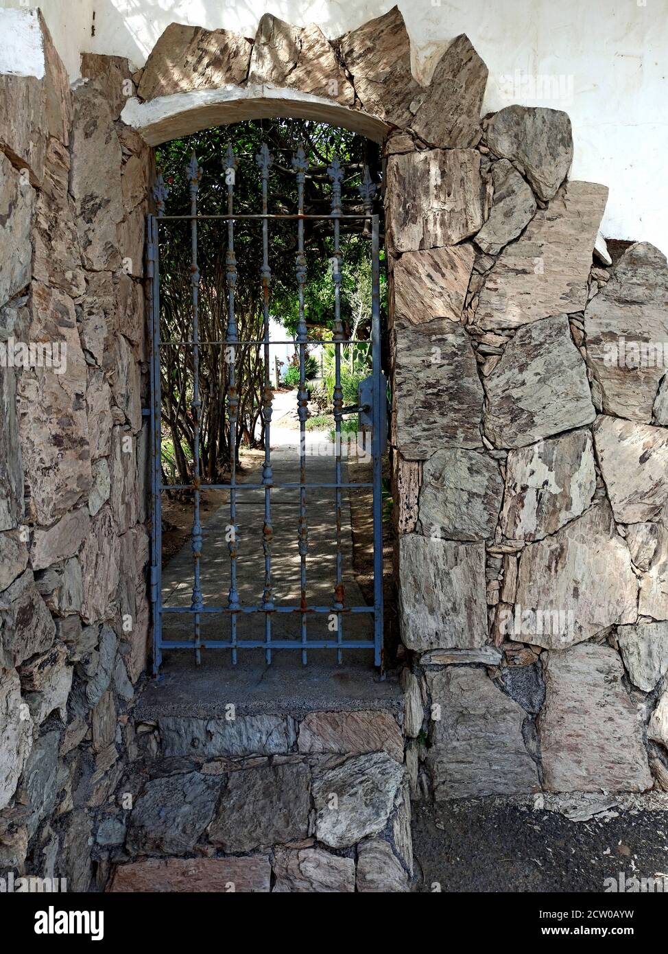 Old garden gate natural stones Stock Photo - Alamy
