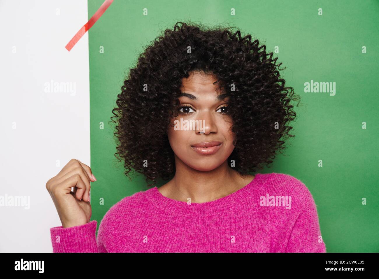 Image of confused african american woman posing and looking at camera ...
