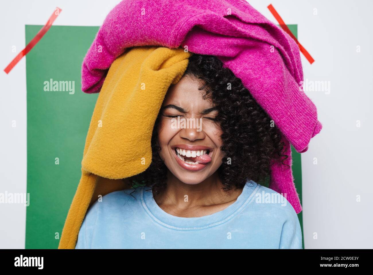 Image of cheerful african american woman laughing with clothes on her ...