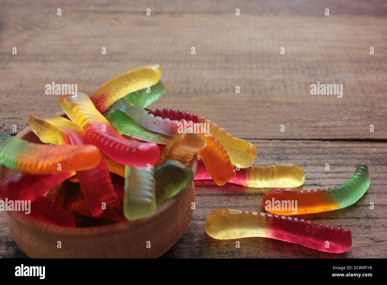 Halloween gummy worms in a bowl. Colorful jelly worms shaped candies ...