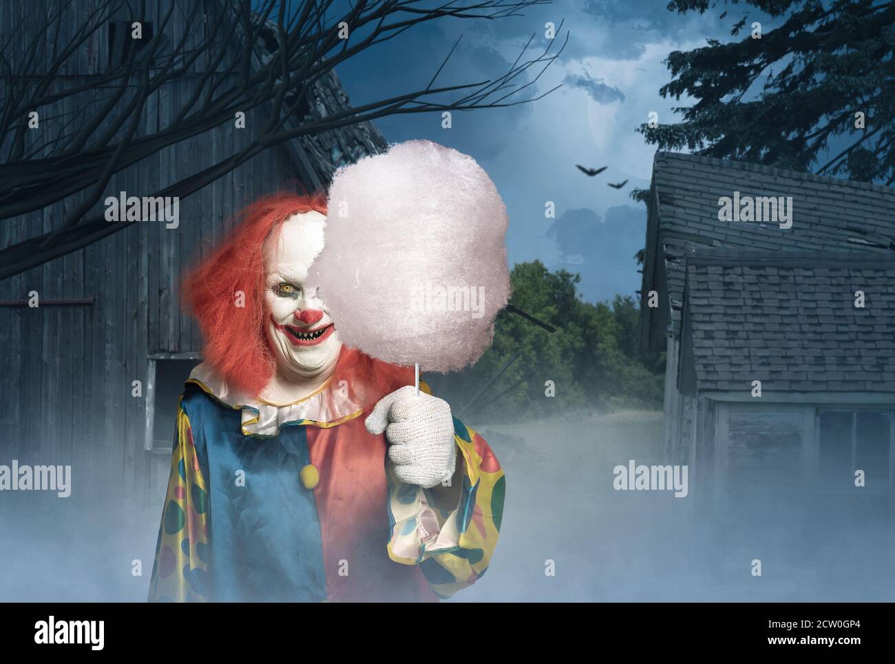 a crazy clown with cotton candy in a dark scene Stock Photo - Alamy