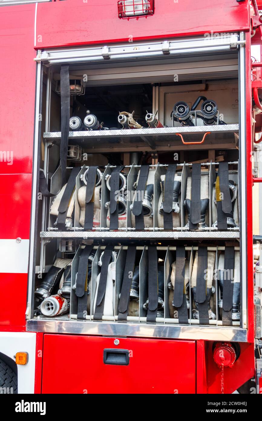 Rescue fire truck equipment. Compartment of the rolled up fire hoses on ...