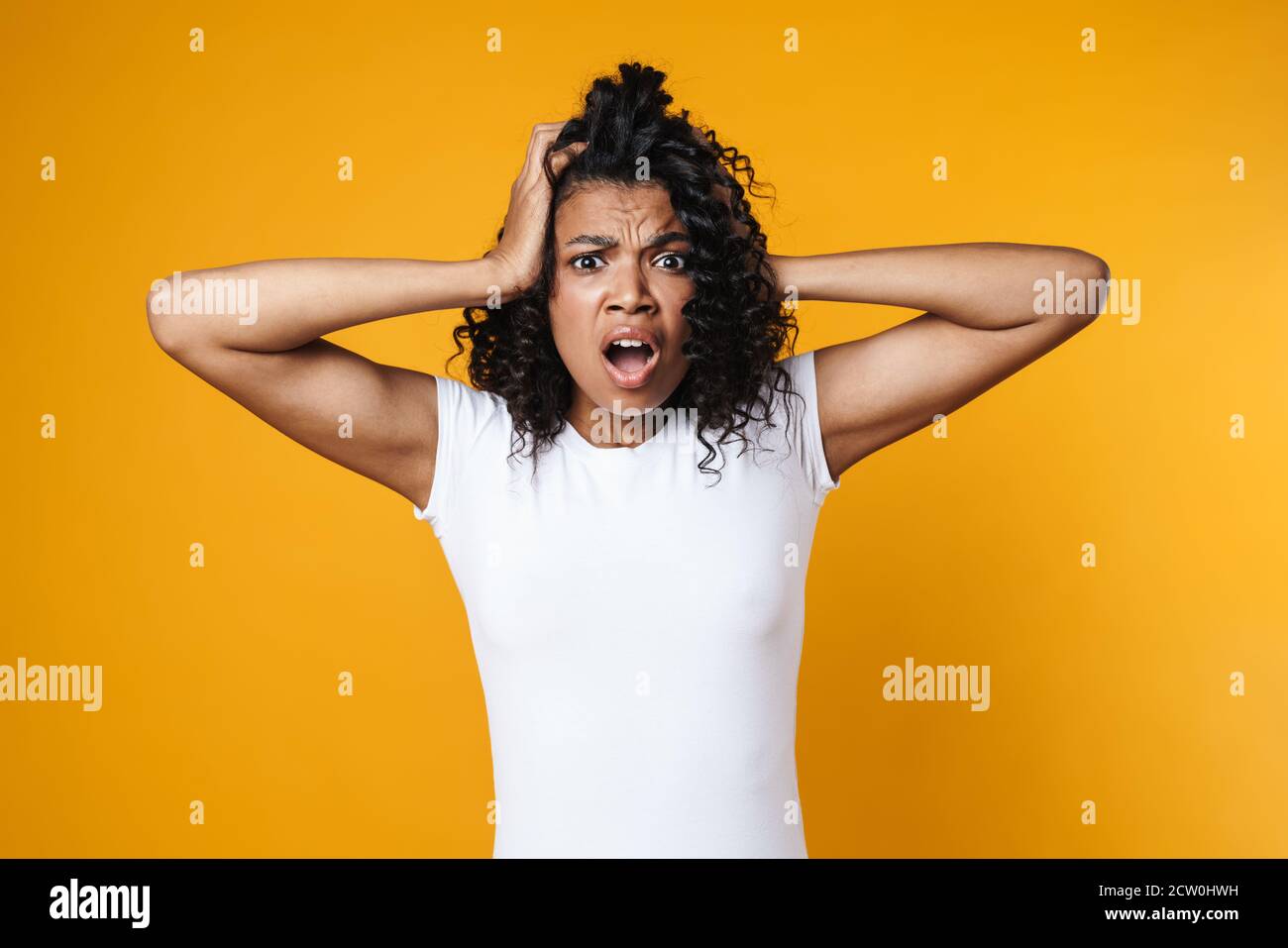 Image of shocked african american woman grabbing her head isolated over ...