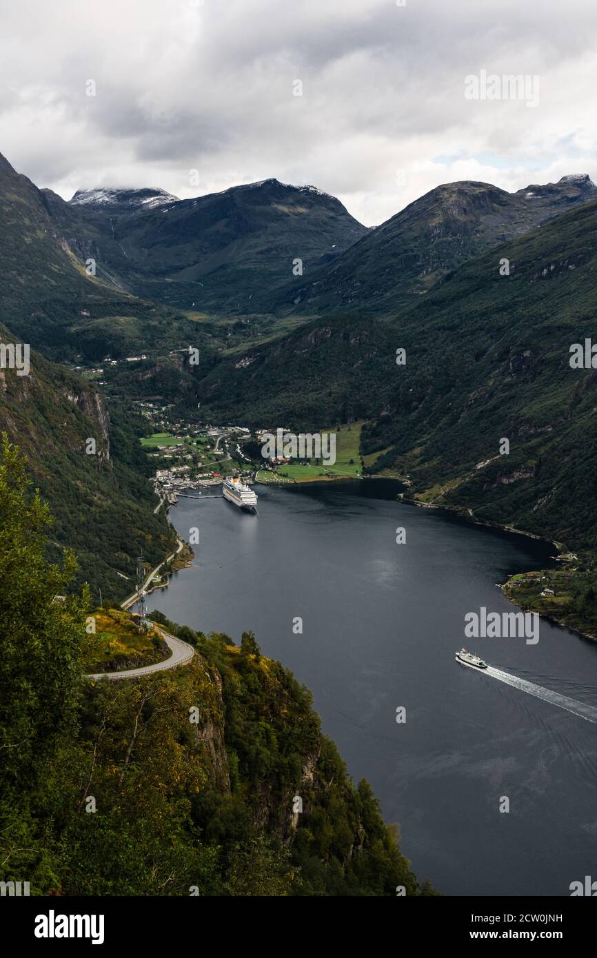 Geiranger fjord with a big cruise ship in port and a small car ferry ...