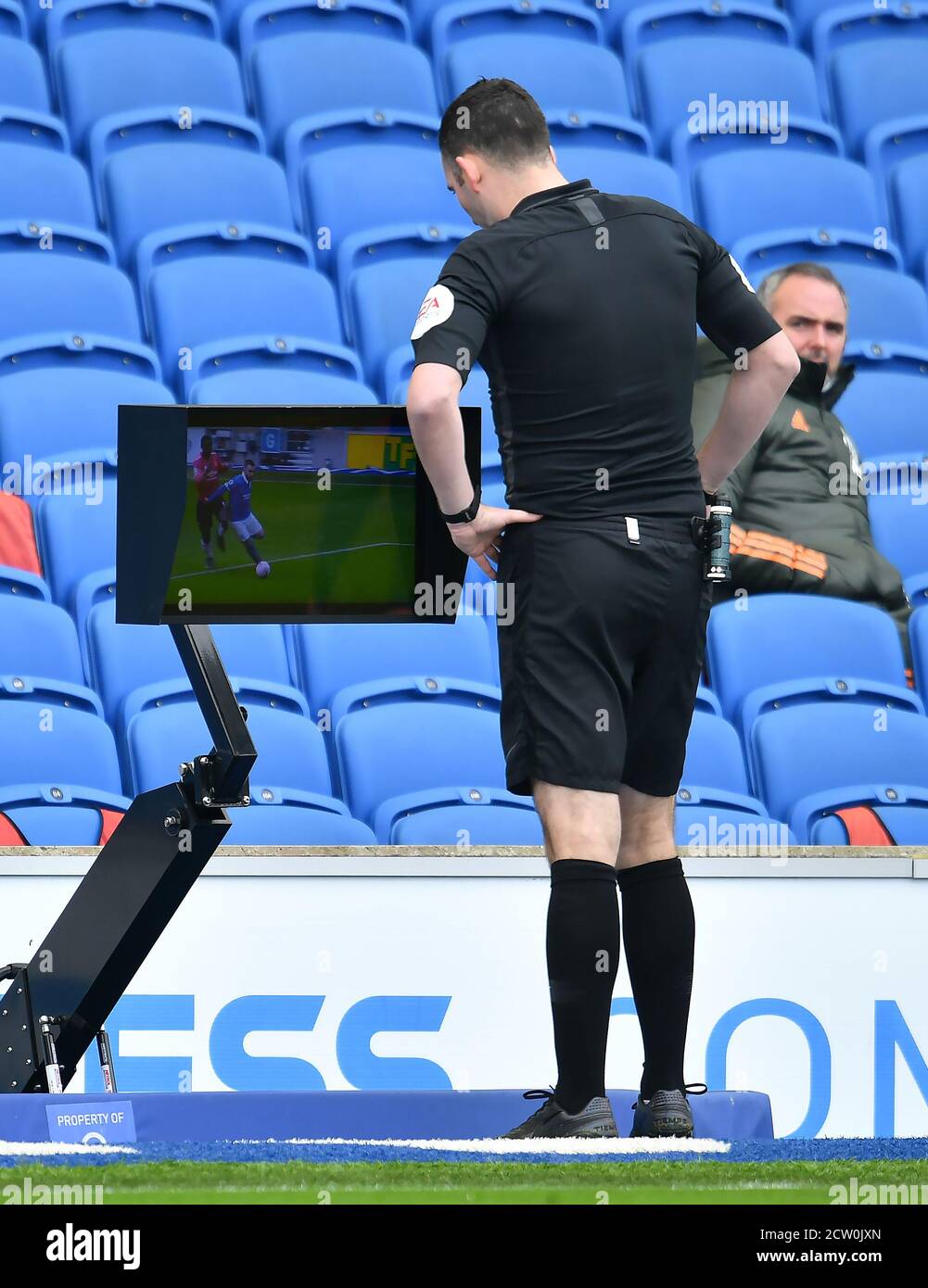 Match referee Chris Kavanagh watches the VAR screen before overturning ...