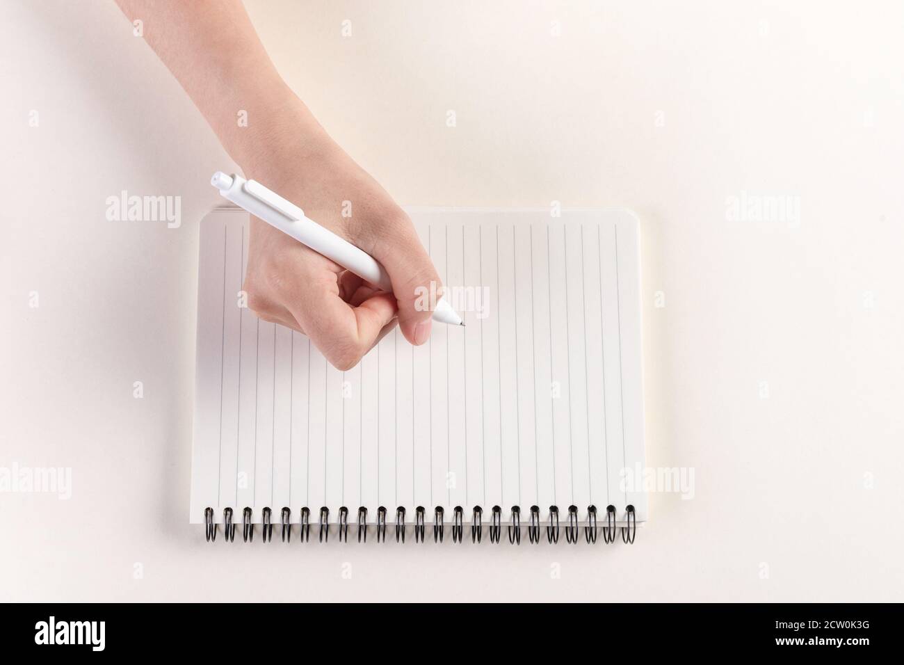 Closeup shot of a hand filling in a diary Stock Photo - Alamy