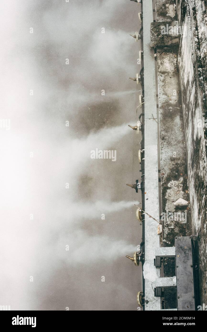 Sewage pumping out steam in the city into the river nearby Stock Photo ...