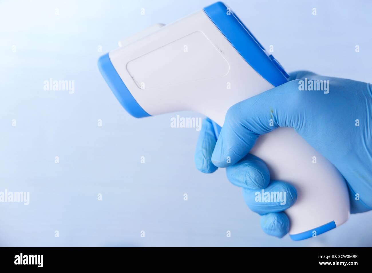 Hand holding infrared thermometer to measuring temperature Stock Photo ...