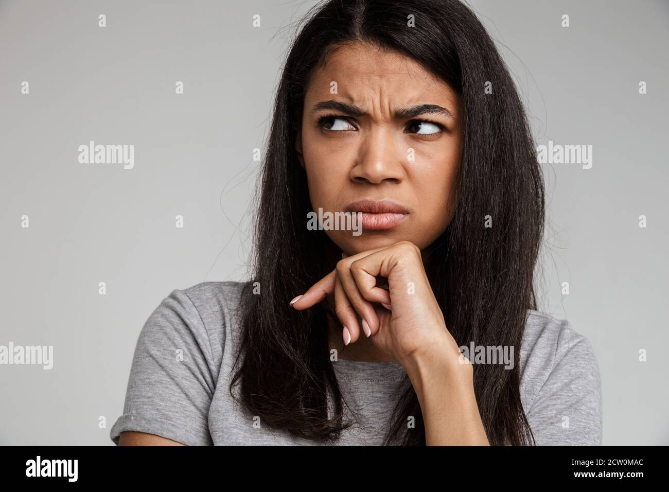 Portrait of young woman thinking deeply about something isolated on ...