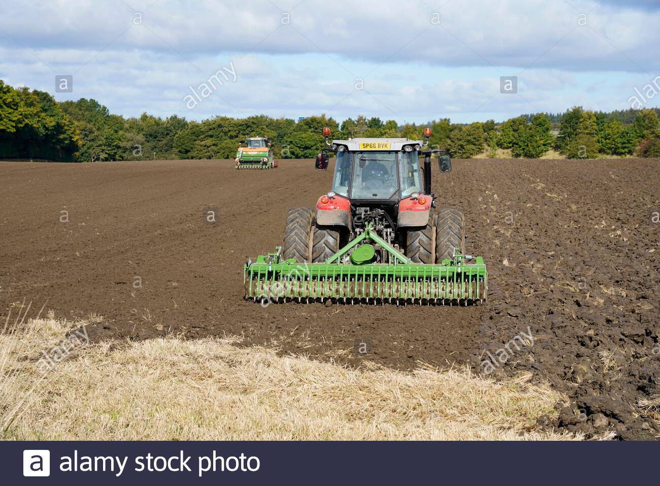 Tractor ploughs red soil hi-res stock photography and images - Alamy