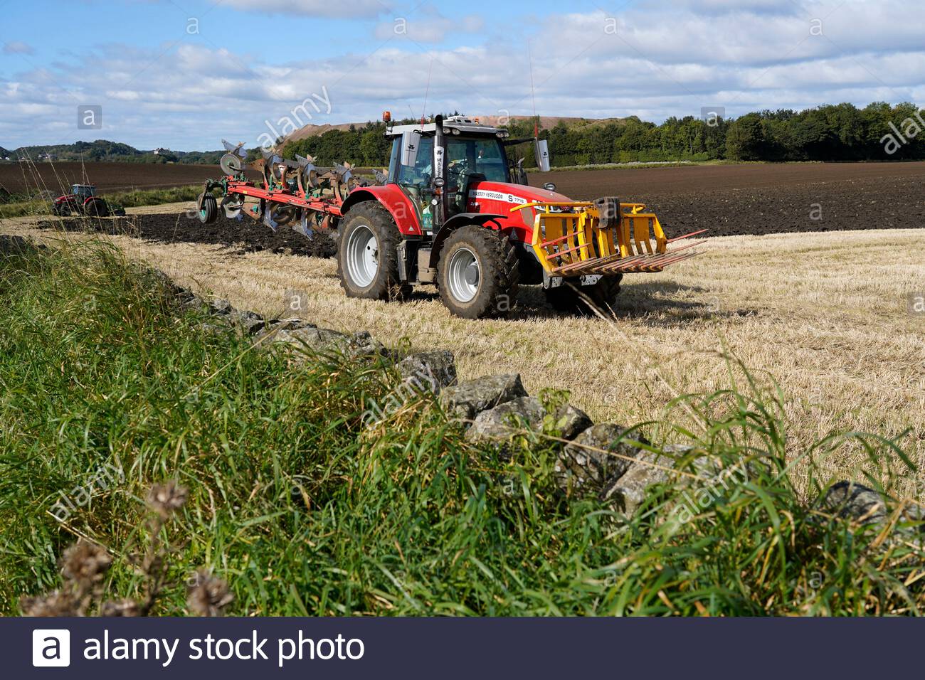 Tractor ploughs red soil hi-res stock photography and images - Alamy