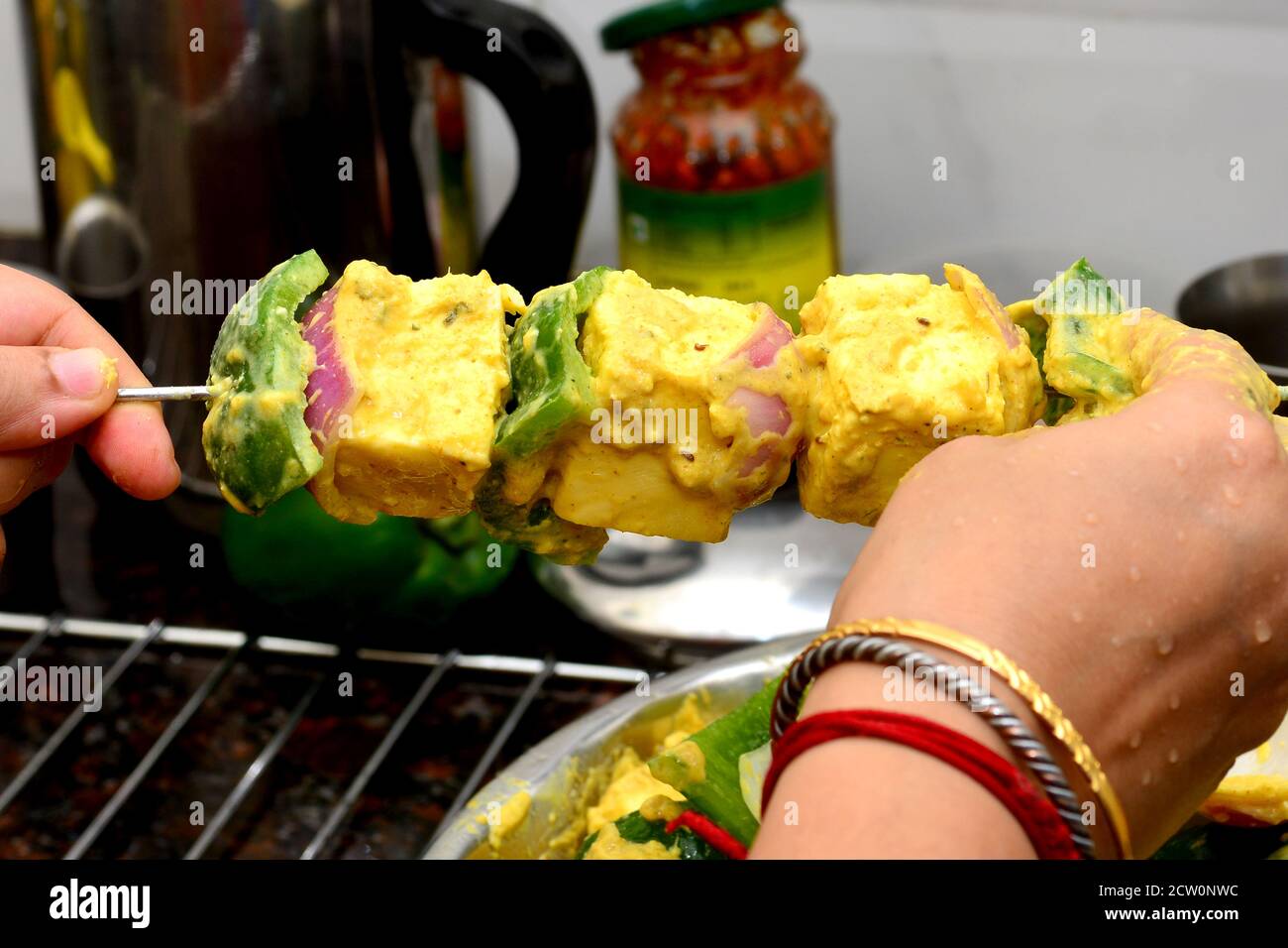 A women skews the marinated Paneer tikka with a texture Stock Photo - Alamy