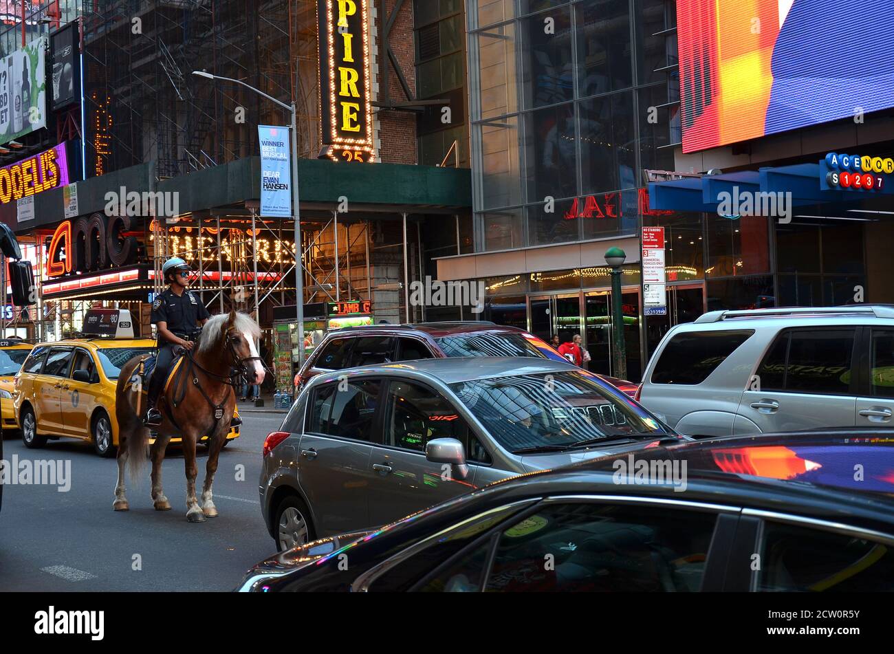 New York City police officer riding a horse down the street Stock Photo ...