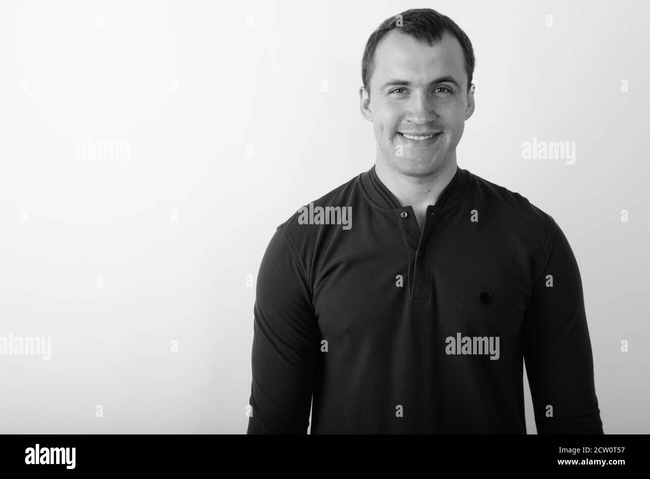 Studio shot of young happy muscular man smiling against white ...