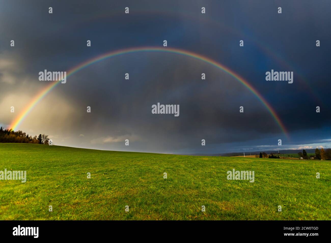 Dopple Rainbow, Thunderstorm is coming with rain, clouds are warm illuminated from the sun,on ...