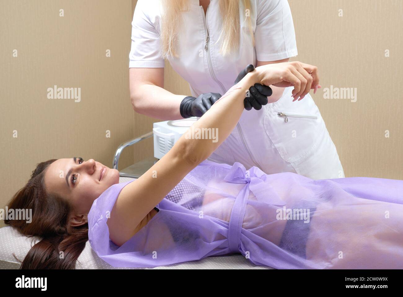 Process of waxing in a beauty salon by a professional beautician ...