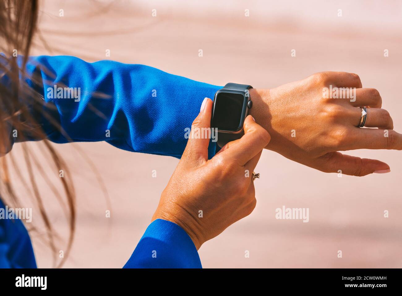 Woman using smart watch. Hands setting smart watch. Checking or setting ...
