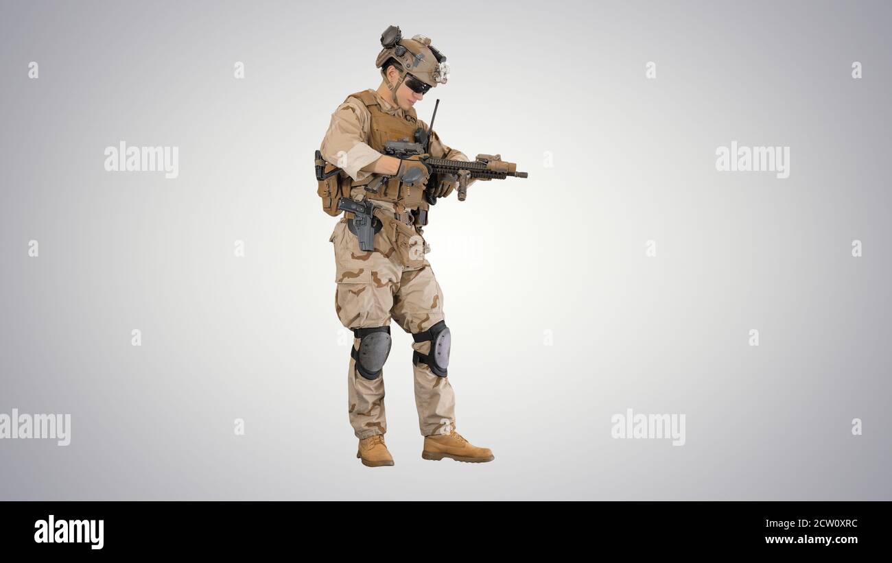 Soldier in camouflage gear checking his uniform and ammunition o Stock ...