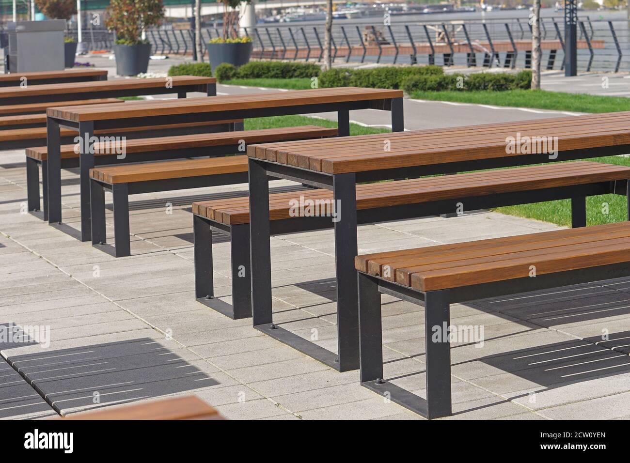 Wooden tables and benches at terrace patio Stock Photo - Alamy